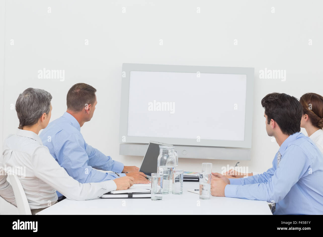 Business team looking at white screen Stock Photo - Alamy
