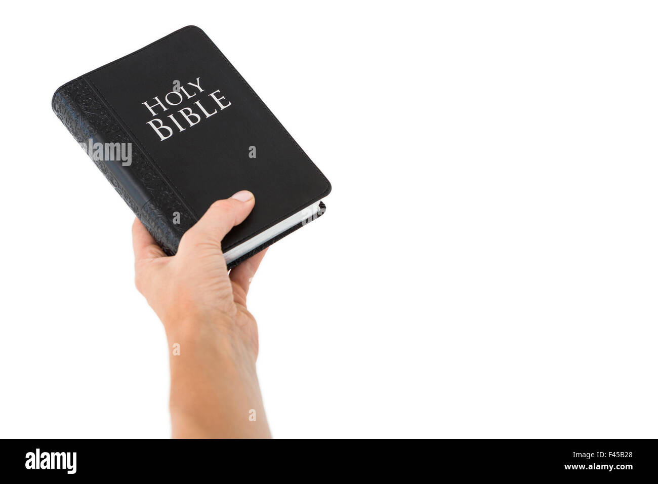 Hand holding bible Stock Photo - Alamy