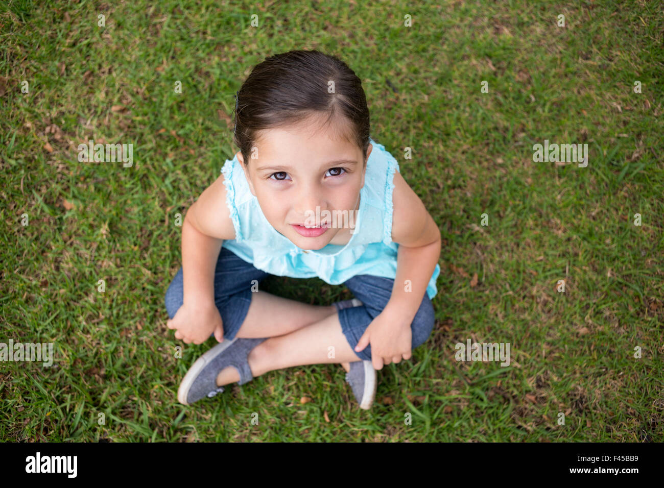 Little girl looking up at camera Stock Photo - Alamy