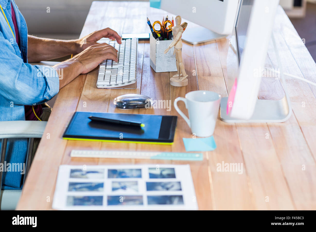 Businessman typing on keyboard at desk Stock Photo - Alamy