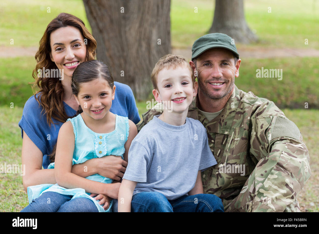 Handsome soldier reunited with family Stock Photo - Alamy