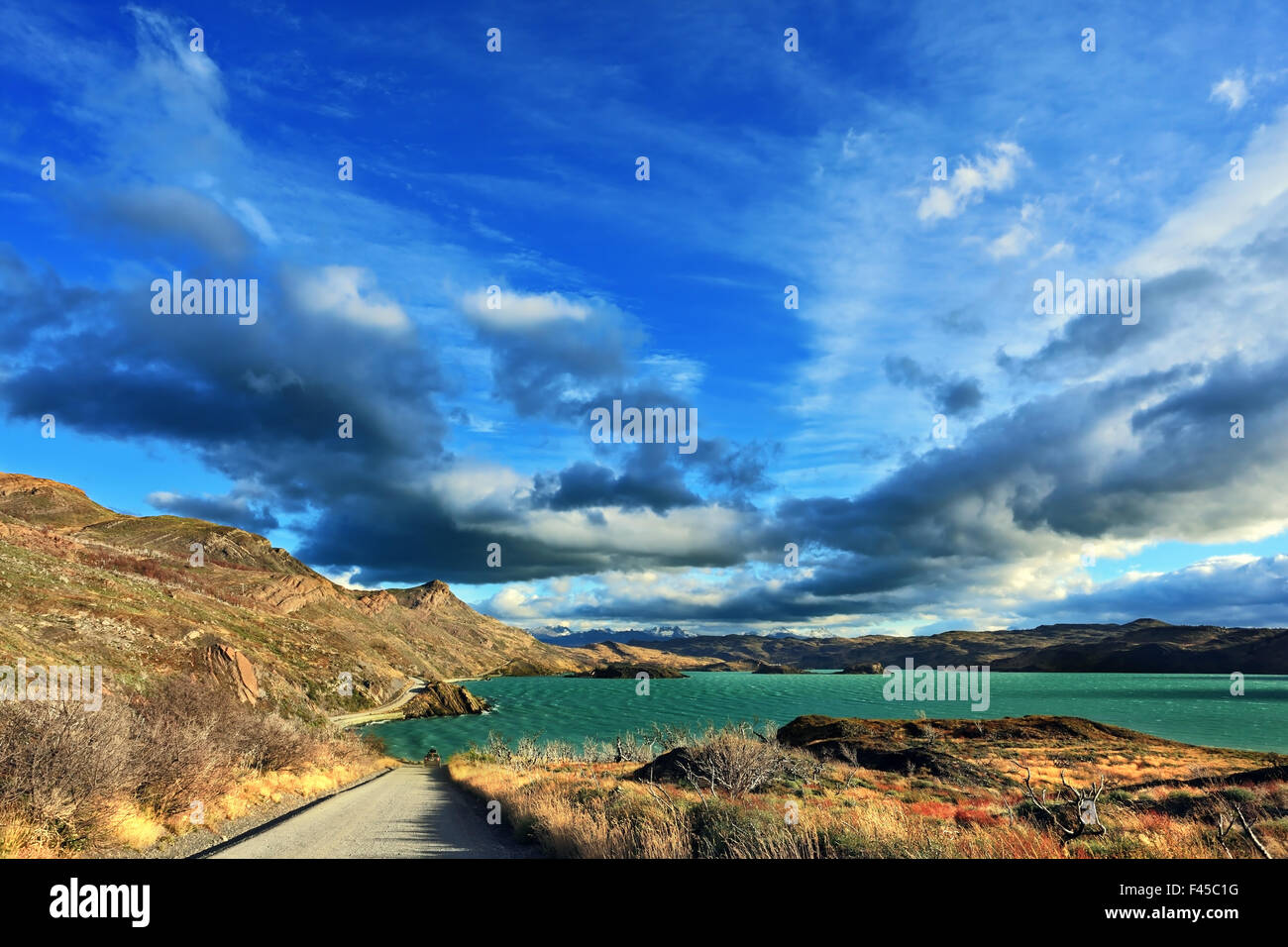 Azure lake and flying in the wind clouds Stock Photo - Alamy