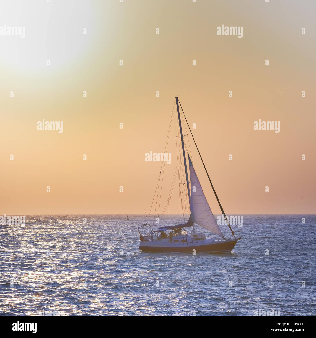 Sail boat against sea sunset Stock Photo - Alamy