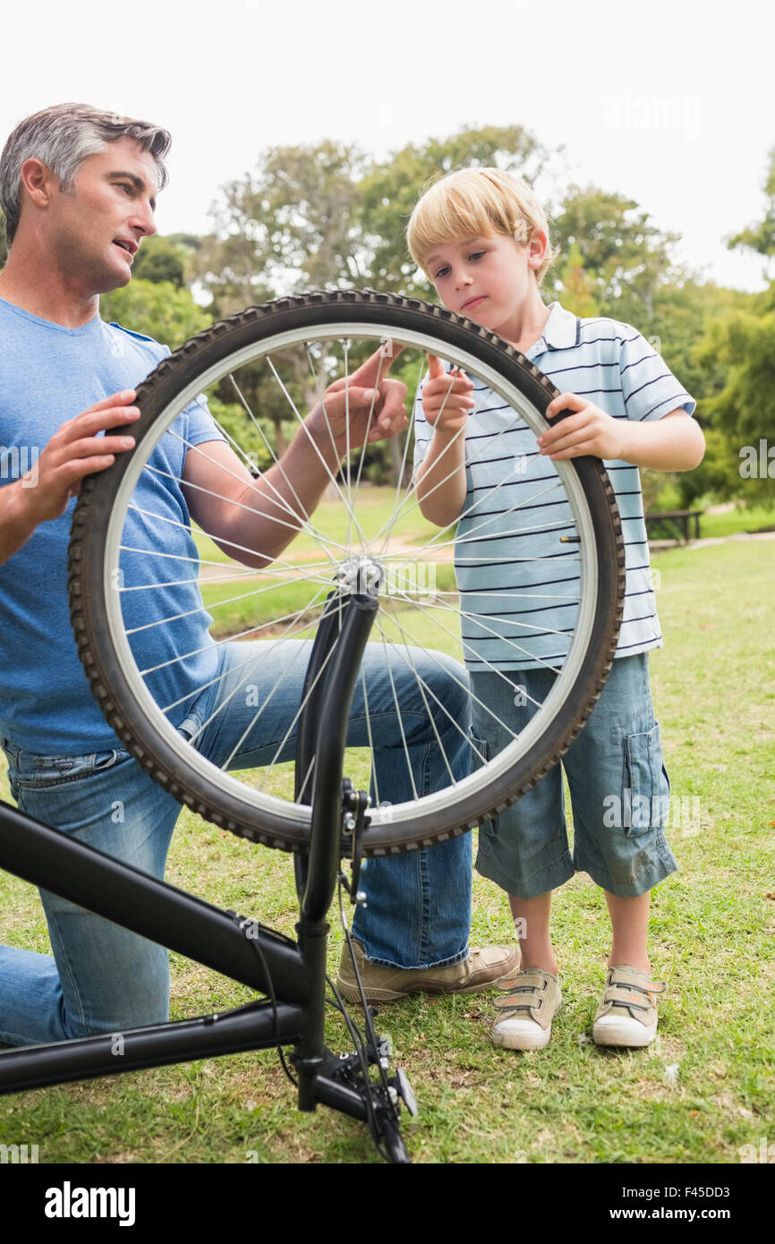 Father and his son fixing a bike Stock Photo - Alamy