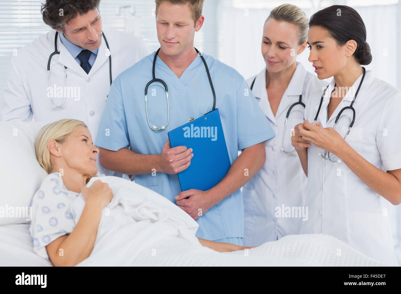 Doctors team with female patient hi-res stock photography and images ...