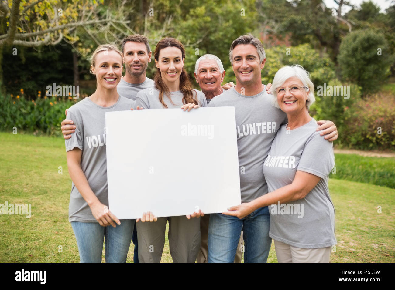 Happy volunteer family holding a blank Stock Photo - Alamy Happy volunteer family holding a blank Stock Photo - Alamy