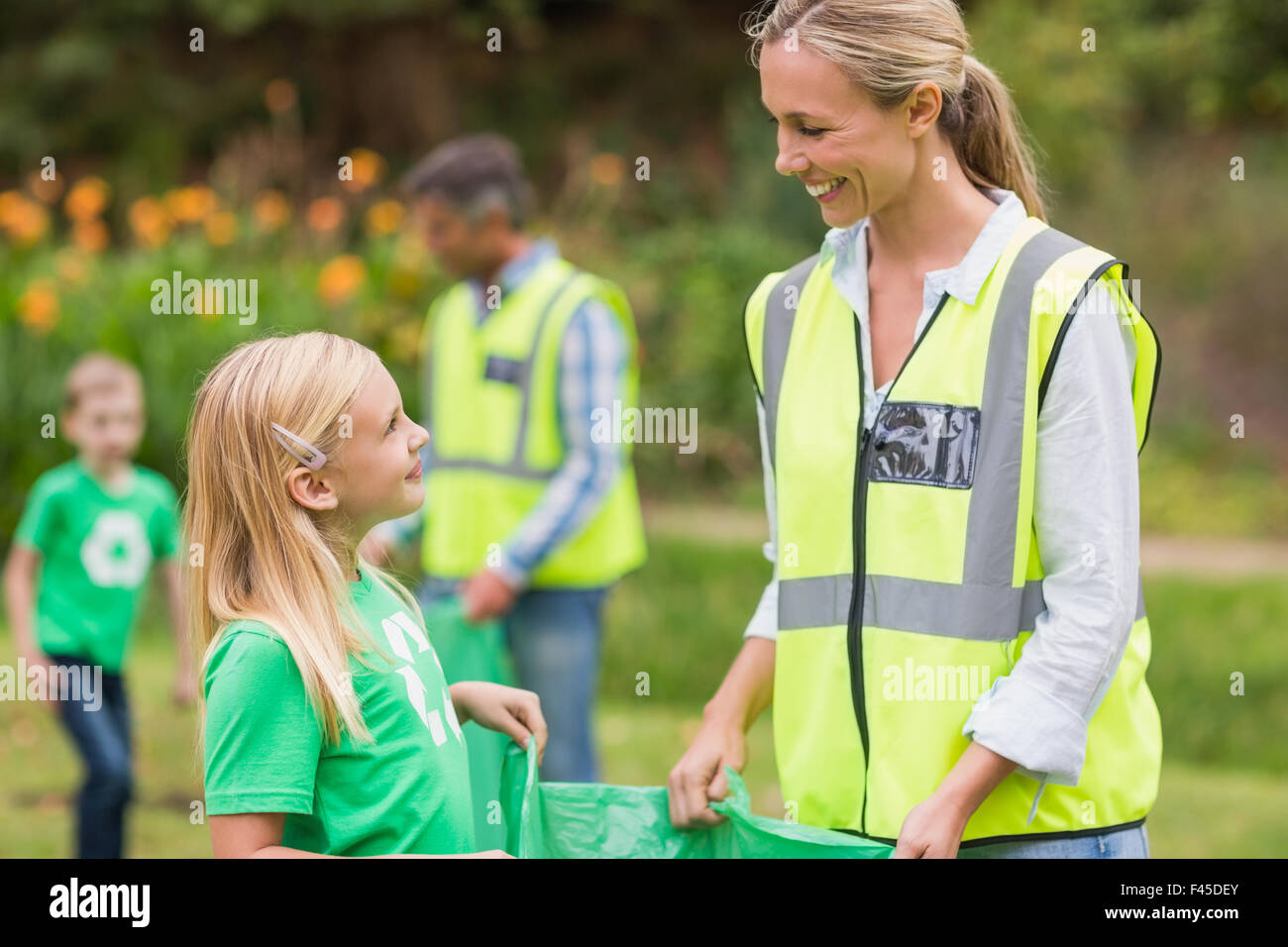 Happy family collecting rubbish Stock Photo - Alamy