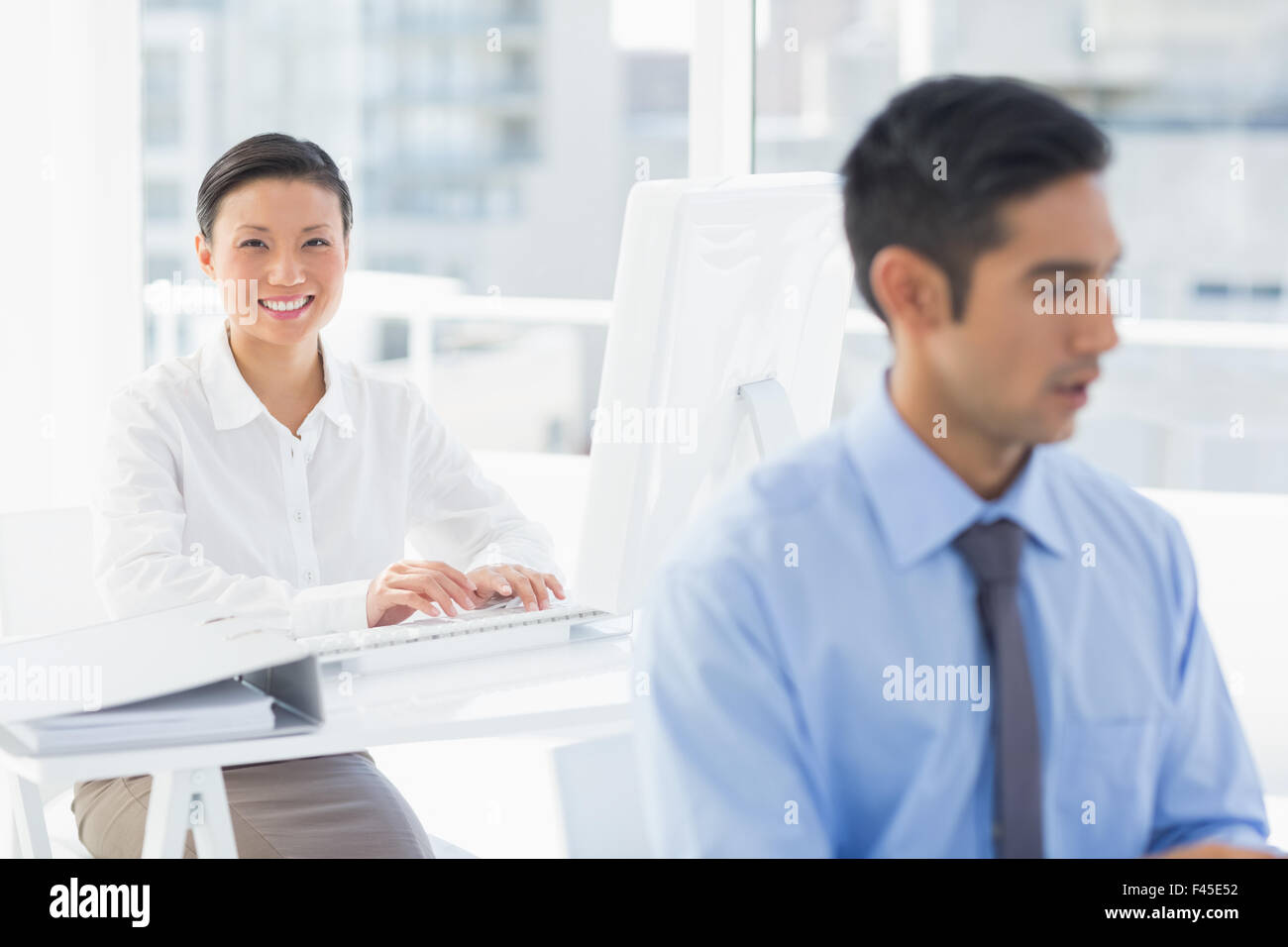 Smiling work team using computer Stock Photo - Alamy