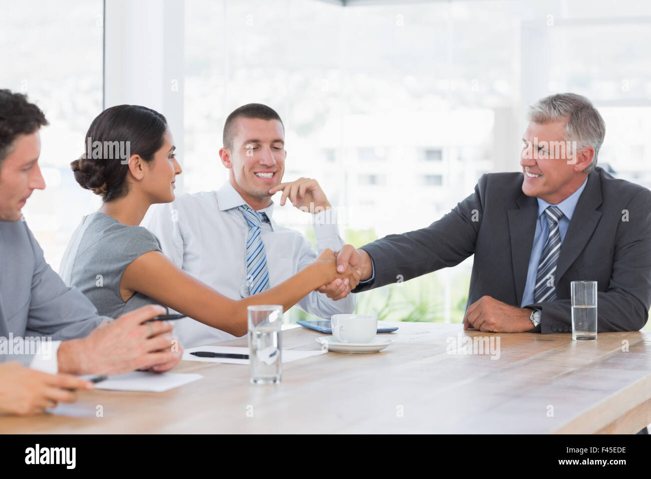 Colleagues greeting each other Stock Photo - Alamy