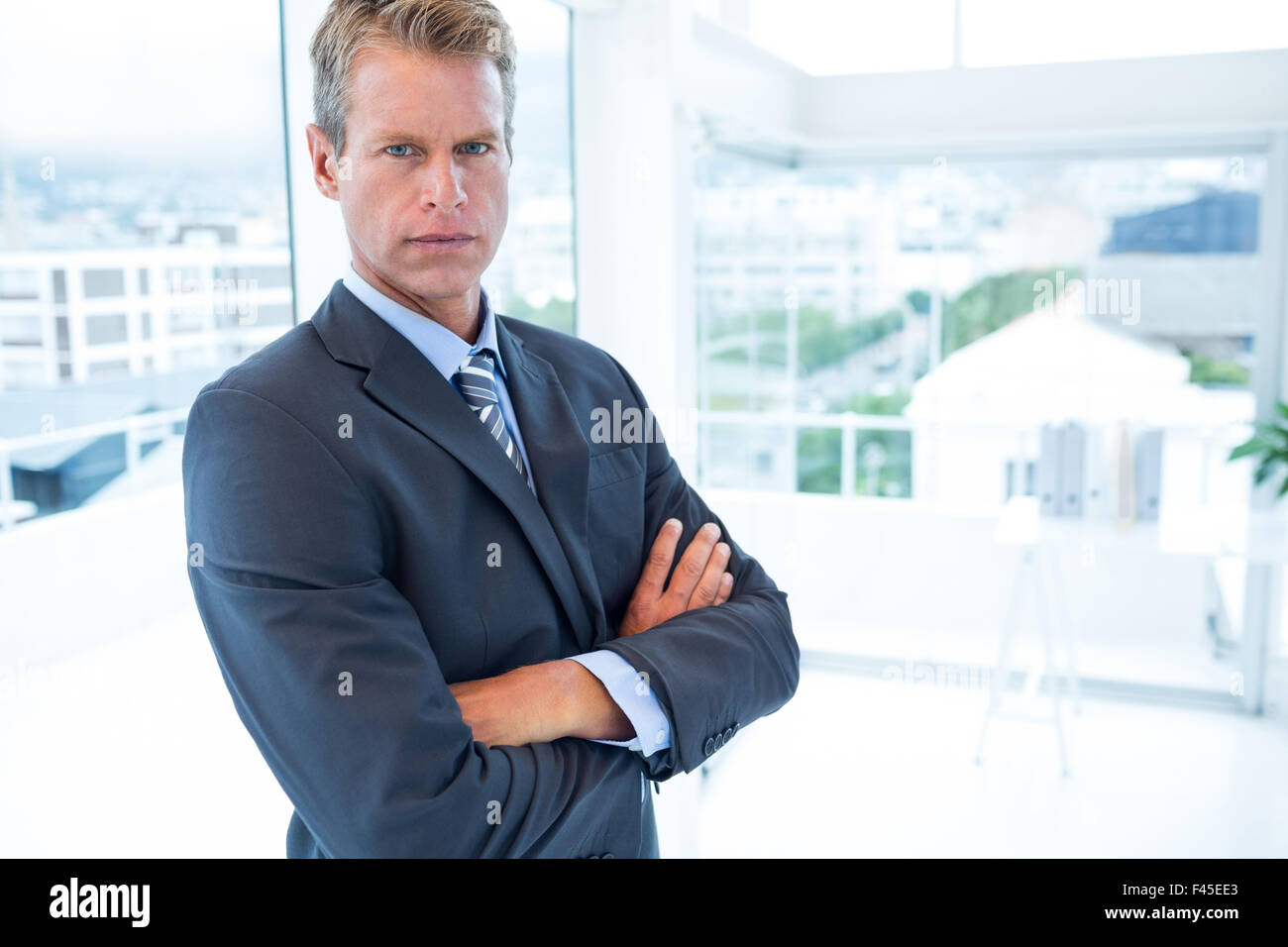 Serious businessman looking at camera Stock Photo - Alamy