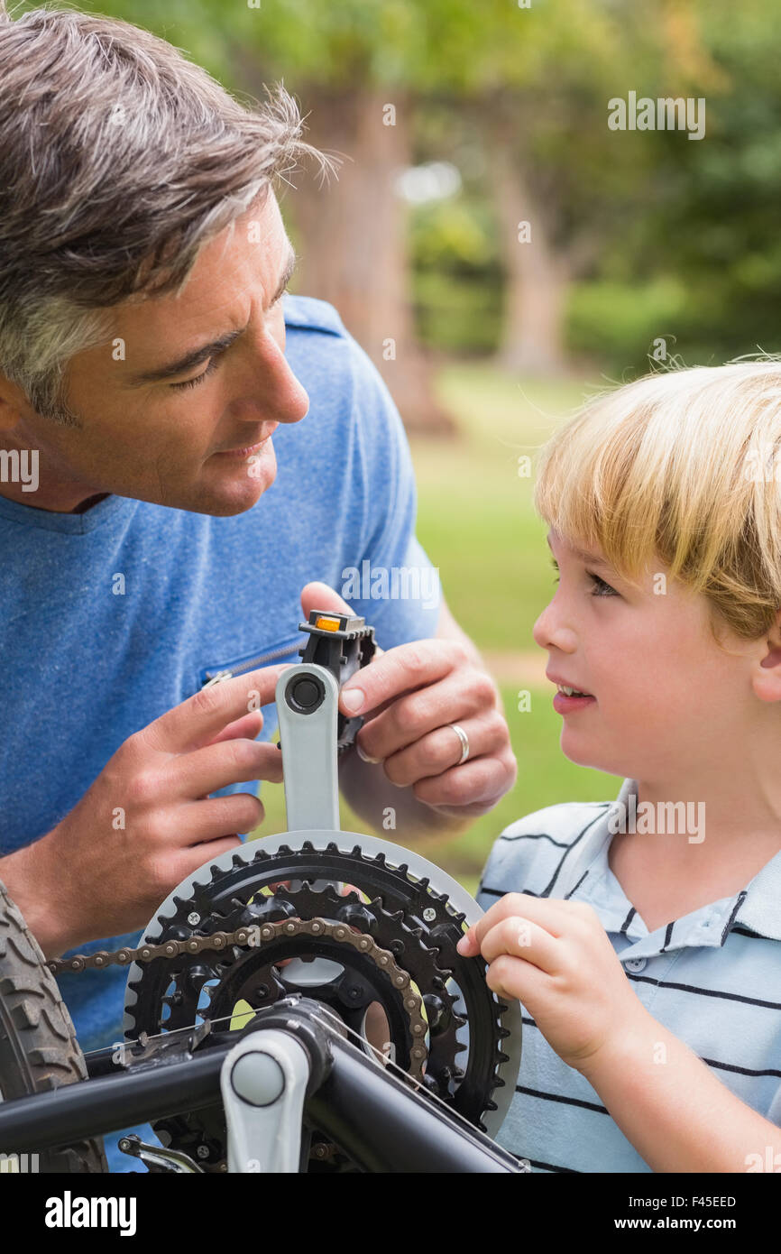 Father and his son fixing a bike Stock Photo - Alamy