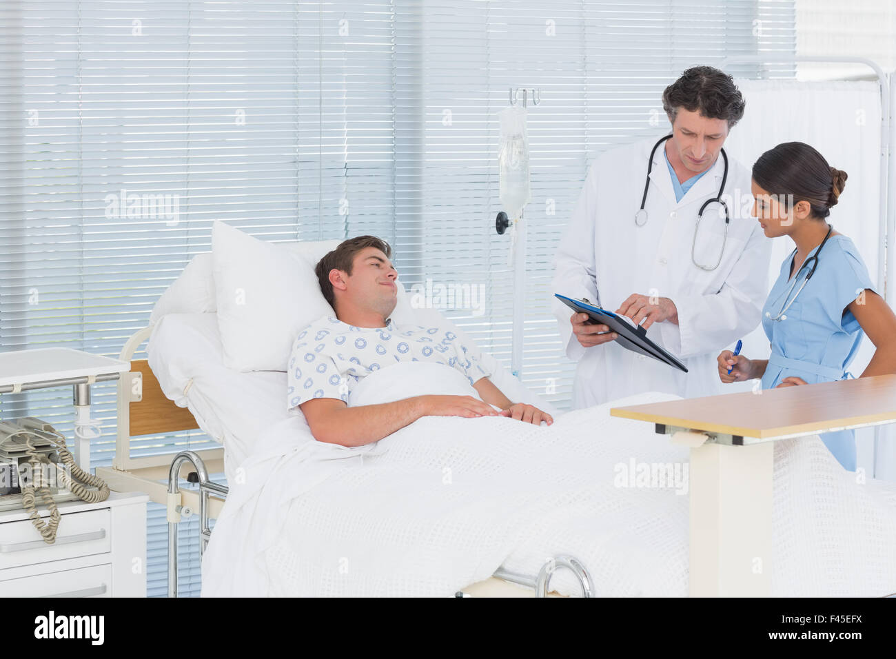 Doctors taking care of patient Stock Photo - Alamy