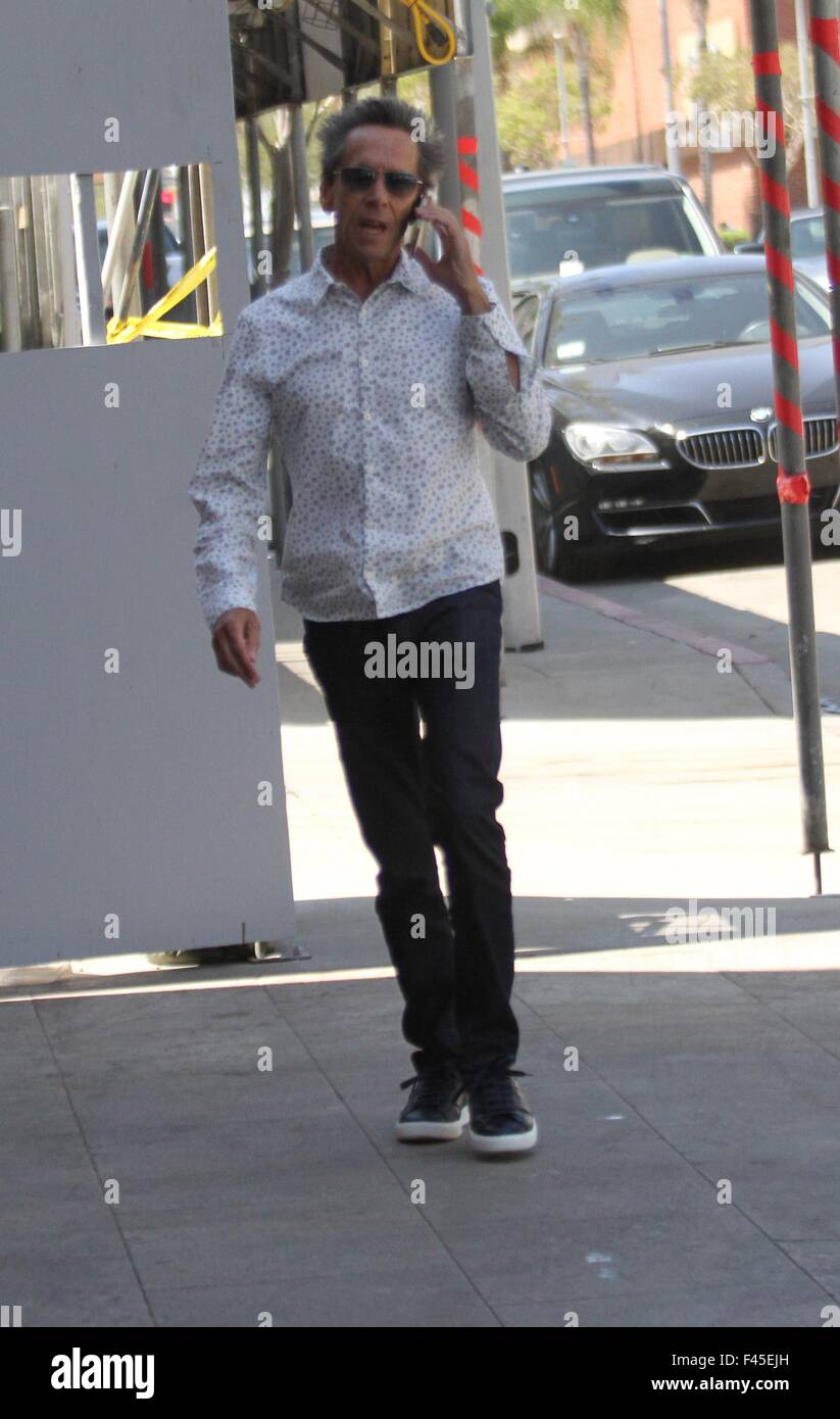 Movie producer Brian Grazer talking on his cellphone while running ...