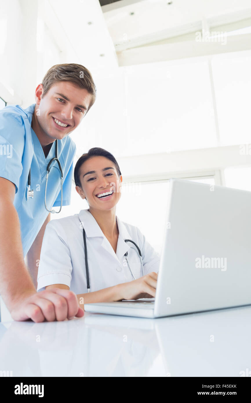 Happy doctors looking at camera Stock Photo - Alamy