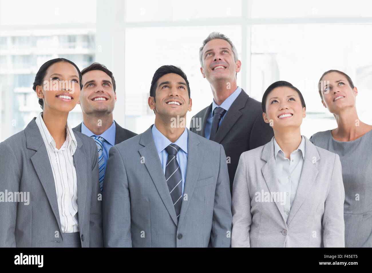 Business people looking up in office Stock Photo - Alamy