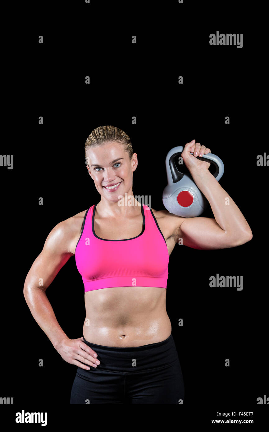 Muscular woman lifting heavy kettlebell Stock Photo - Alamy
