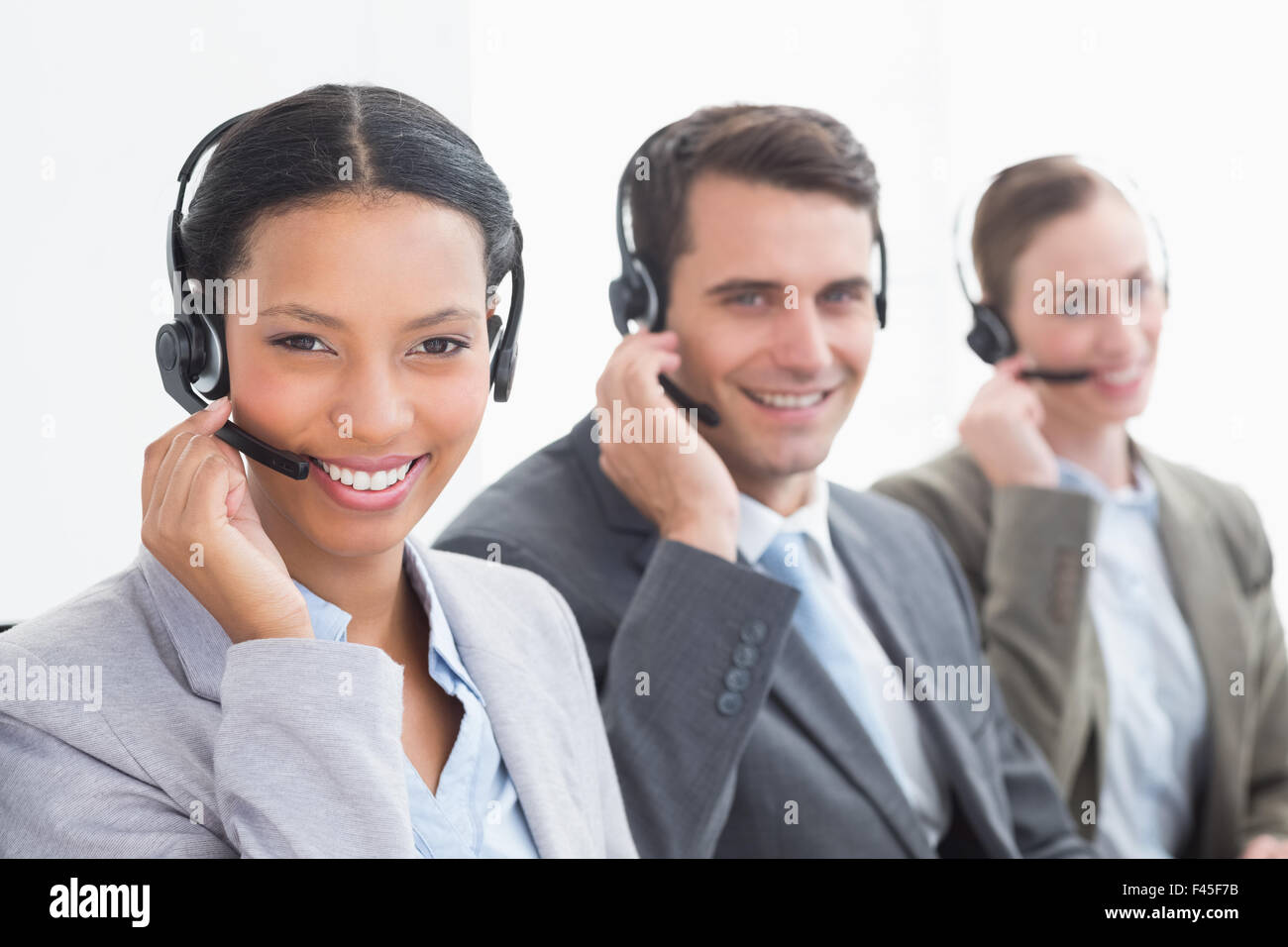Business people with headsets using computers Stock Photo - Alamy
