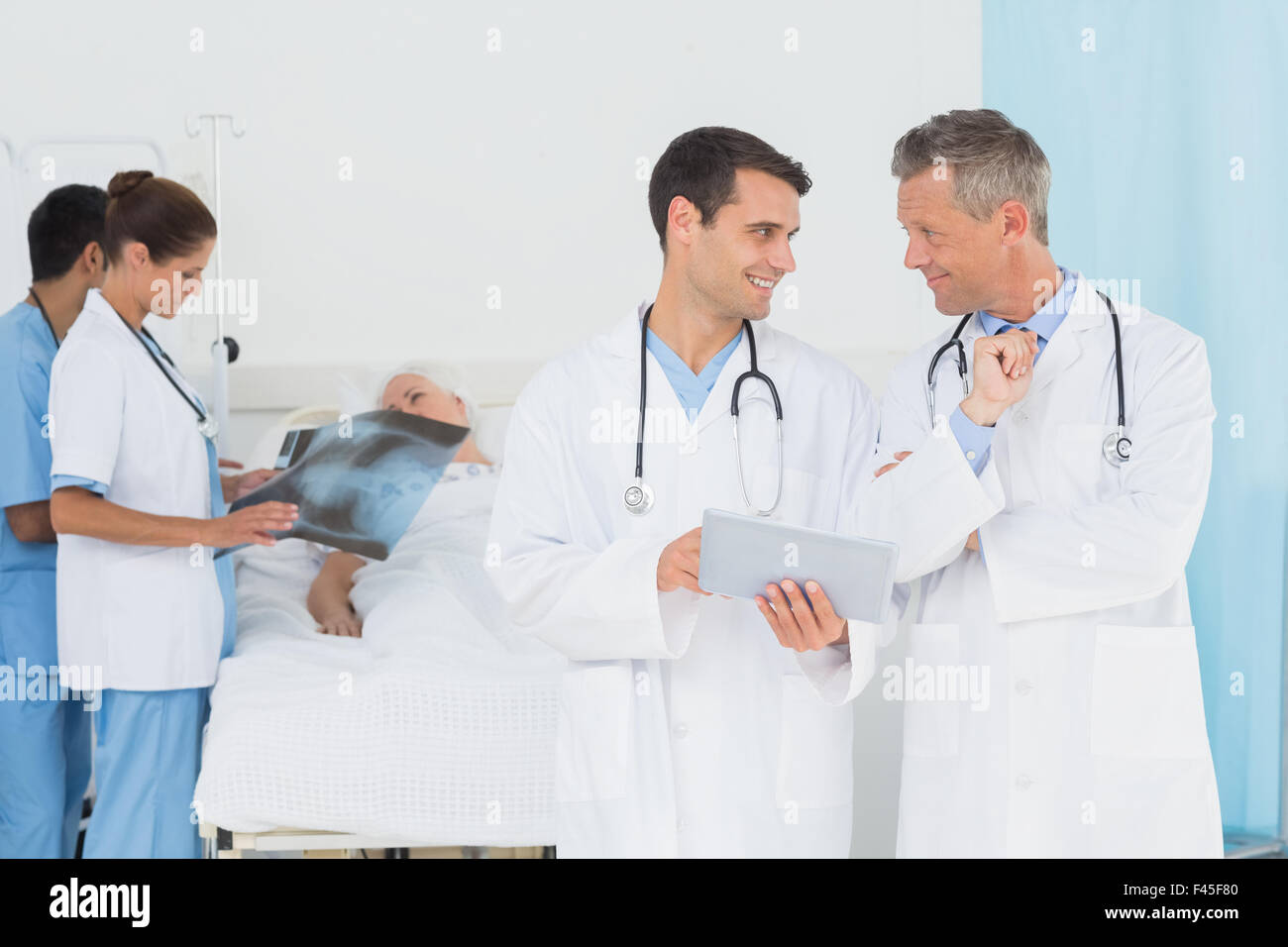 Report reading with patient behind Stock Photo - Alamy