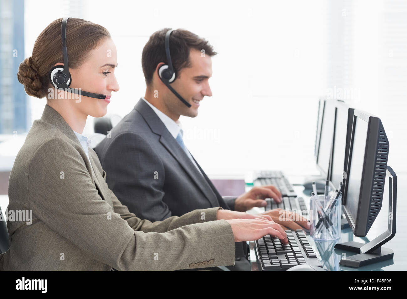 Smiling business people using headsets hi-res stock photography and ...