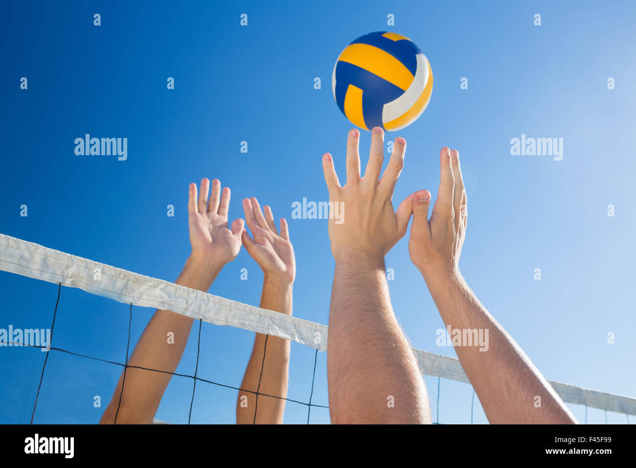 Friends playing volleyball Stock Photo - Alamy
