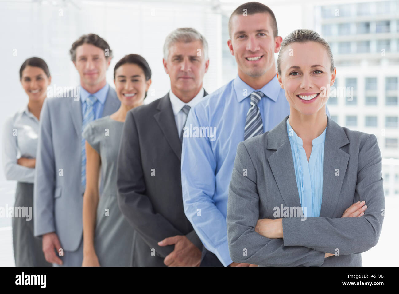Smiling business team standing in a line Stock Photo - Alamy
