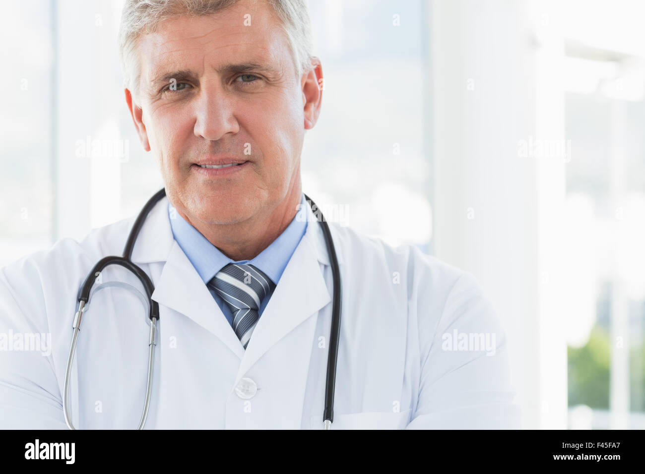 Confident male doctor looking at camera Stock Photo - Alamy
