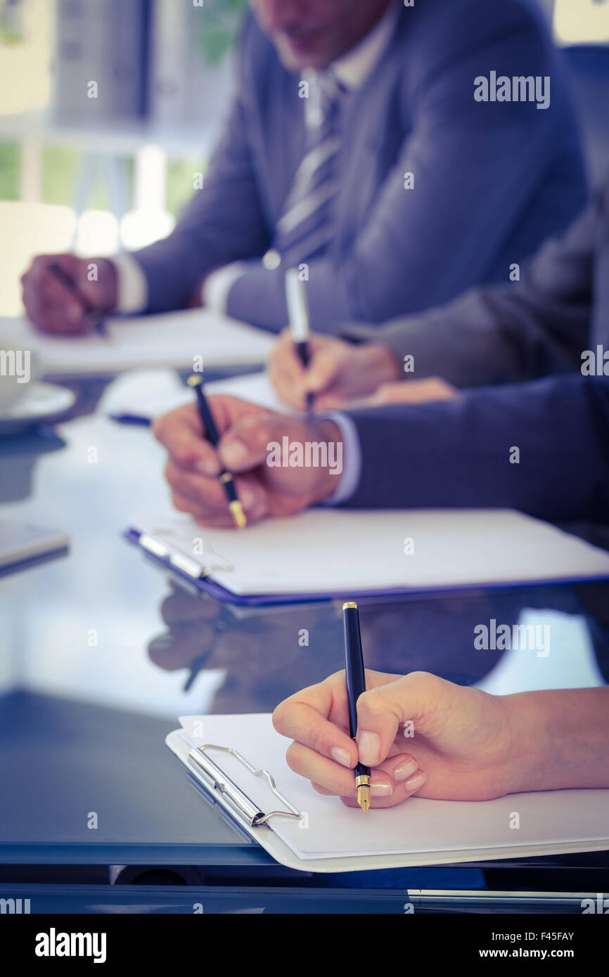 Business team taking notes at meeting Stock Photo - Alamy