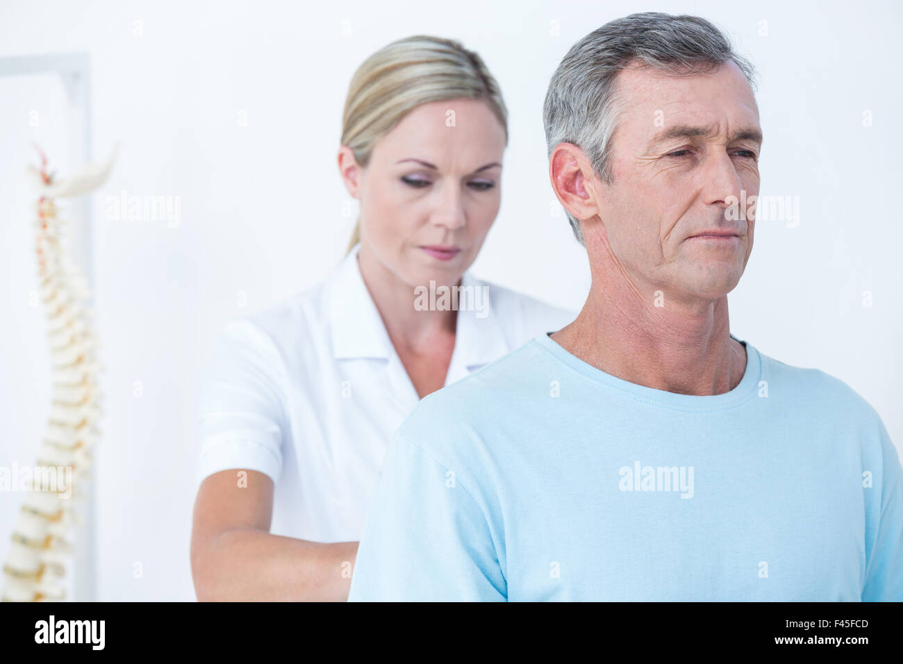 Doctor examining her patient back Stock Photo - Alamy