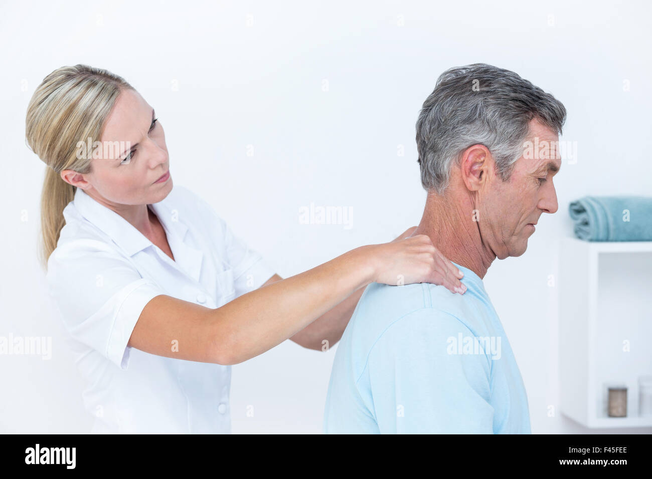 Doctor stretching her patient neck Stock Photo - Alamy