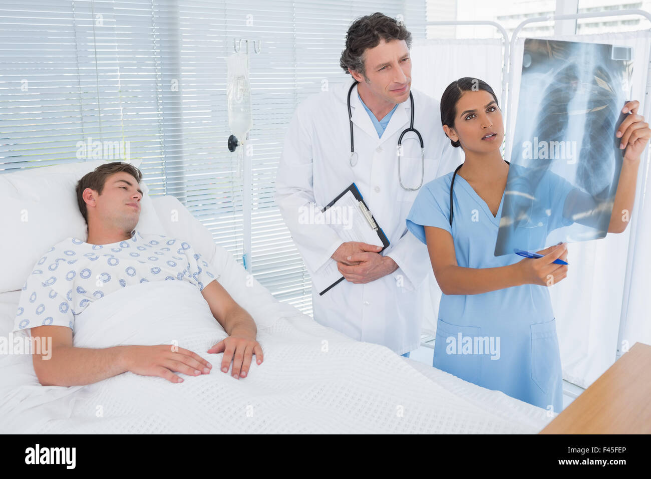 Doctors examining patients xray Stock Photo - Alamy