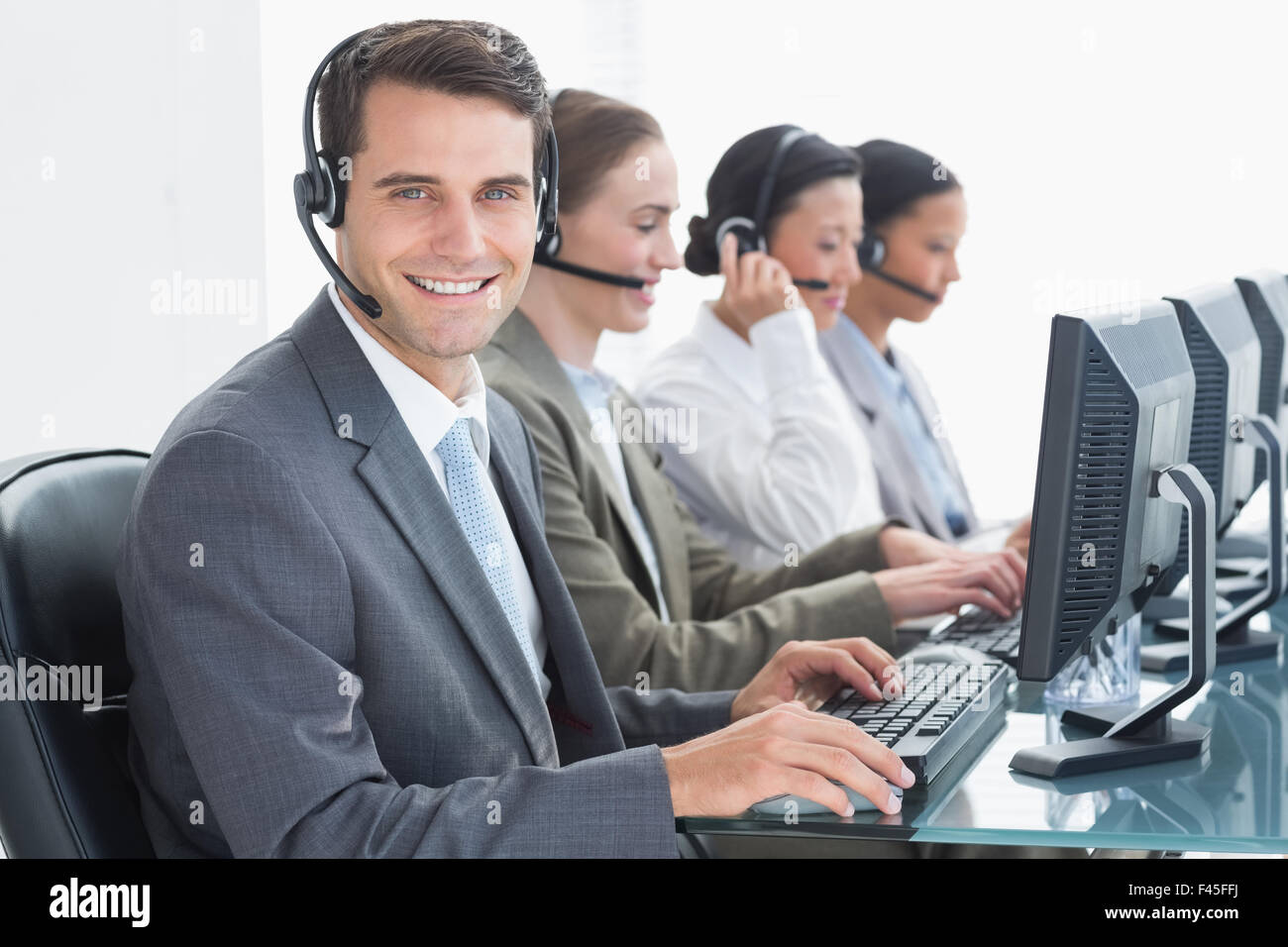 Business people with headsets using computers Stock Photo - Alamy