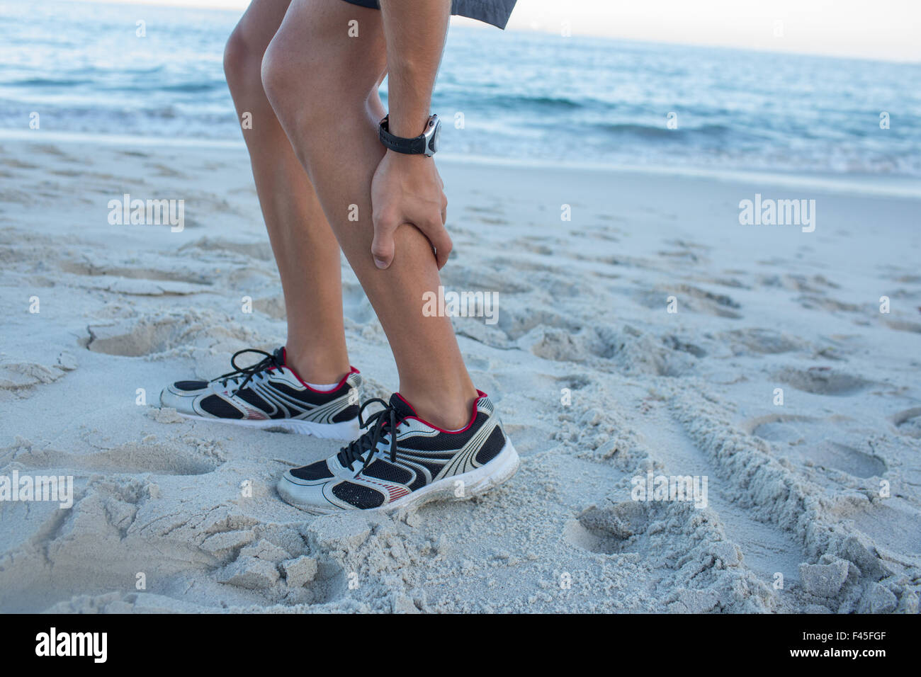 Fit man having muscle pain Stock Photo - Alamy