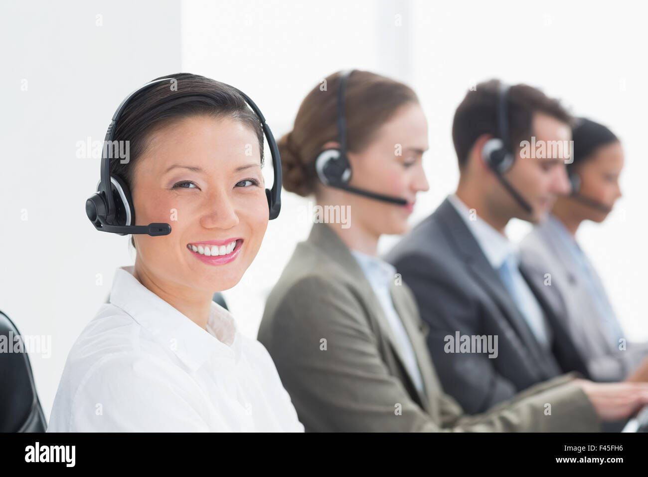 Business people with headsets using computers Stock Photo - Alamy