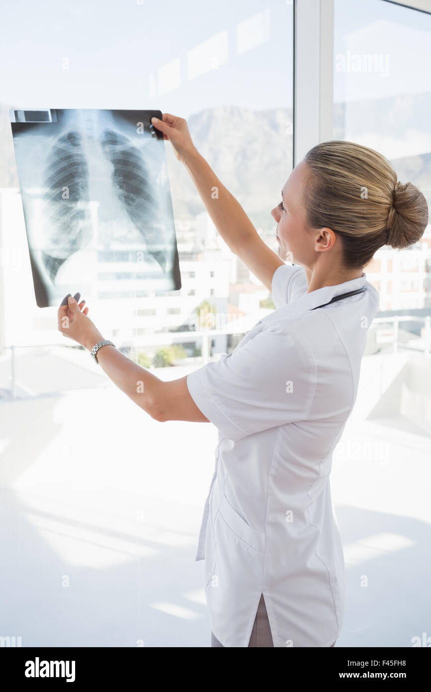 Doctor looking at Xray beside windows Stock Photo - Alamy