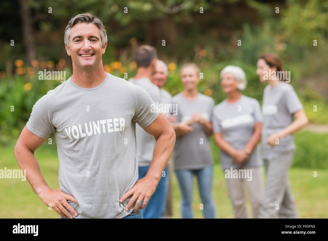 Smiling volunteer looking at camera Stock Photo - Alamy