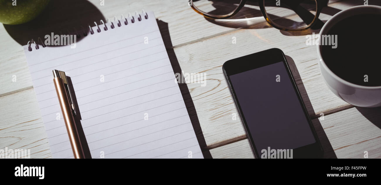 Overhead shot of notepad and smartphone Stock Photo - Alamy