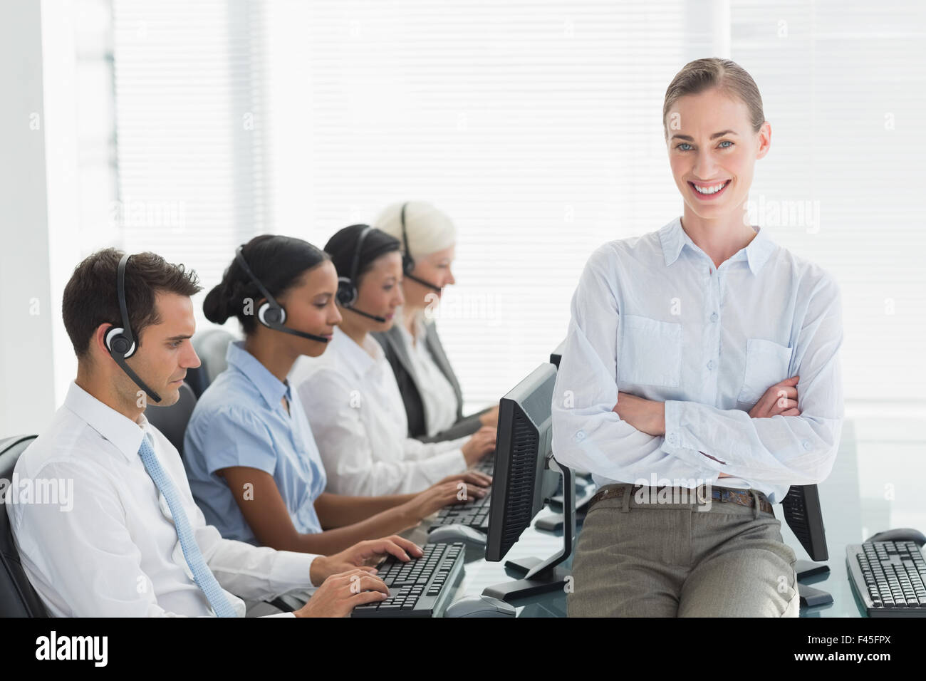 Businesswoman with executives using computers Stock Photo - Alamy