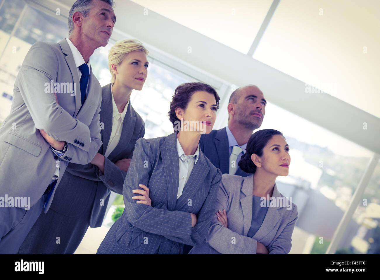 Business team looking up together Stock Photo - Alamy