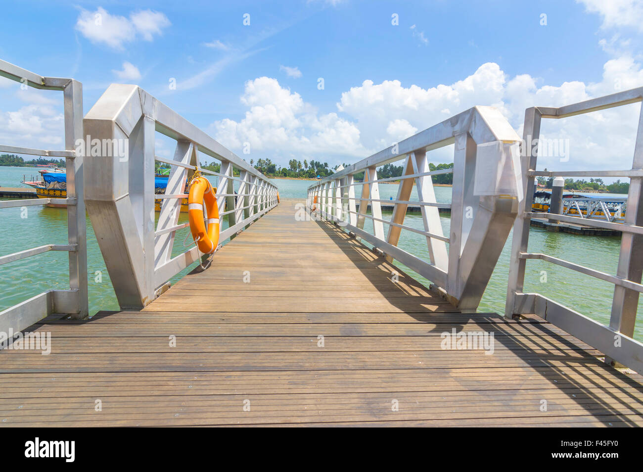 Jetty boat with blue skies Stock Photo - Alamy