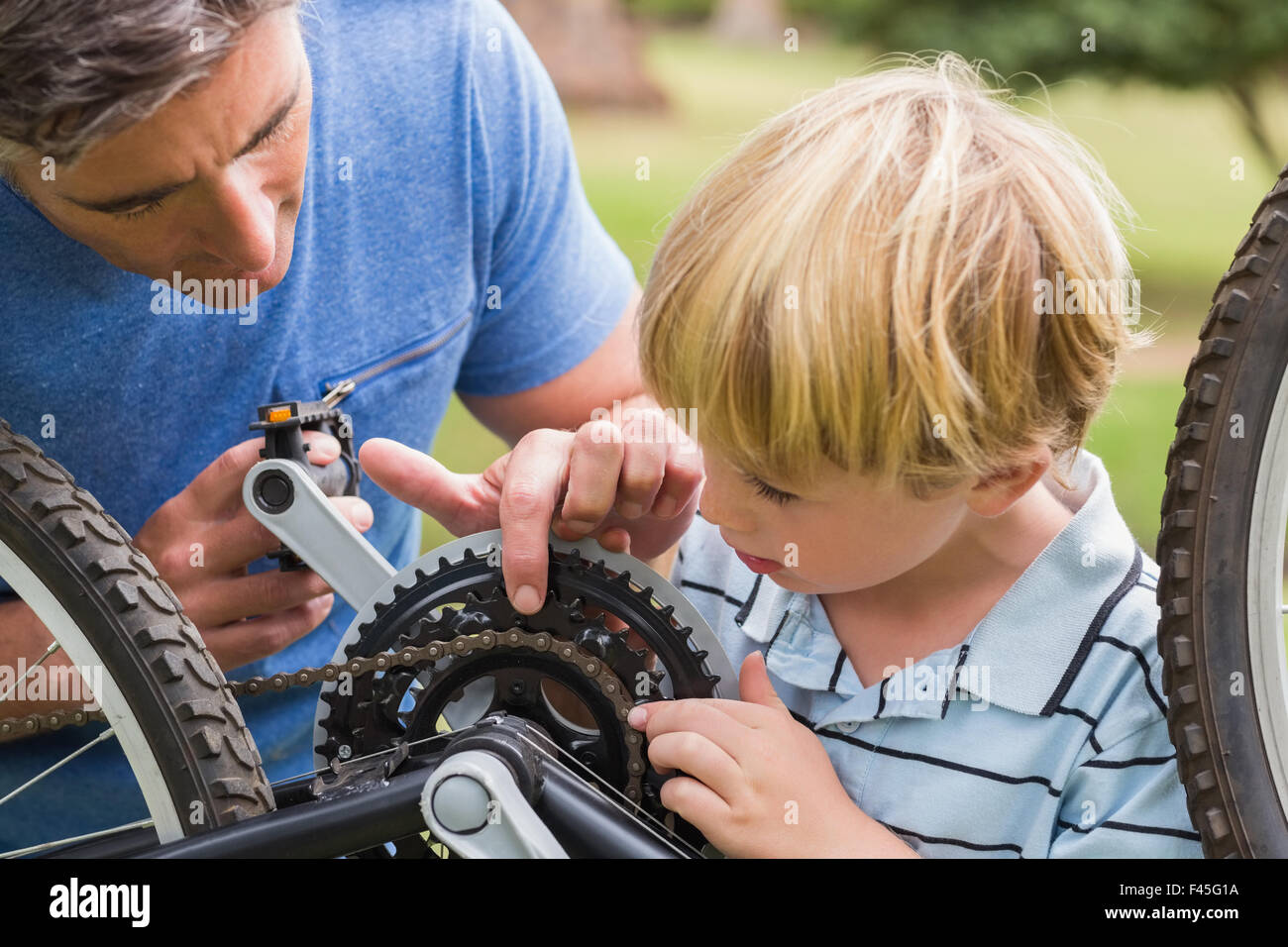 Father and his son fixing a bike Stock Photo - Alamy