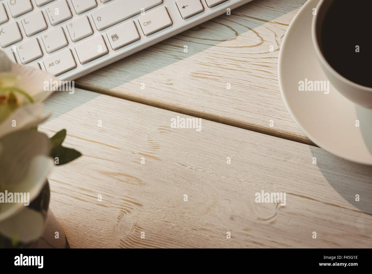 White keyboard and cup of coffee Stock Photo - Alamy