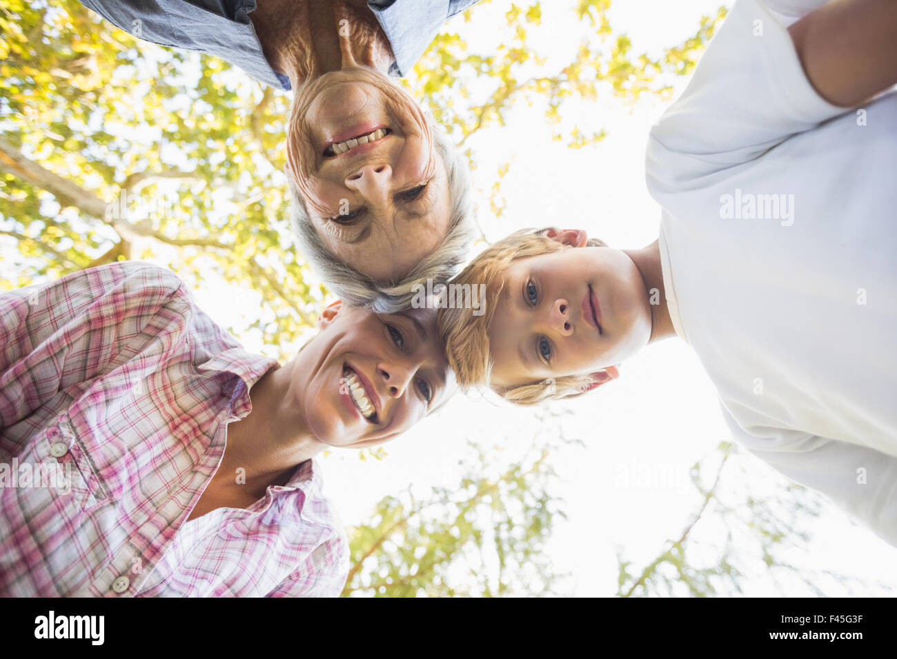 Happy family looking down the camera Stock Photo - Alamy