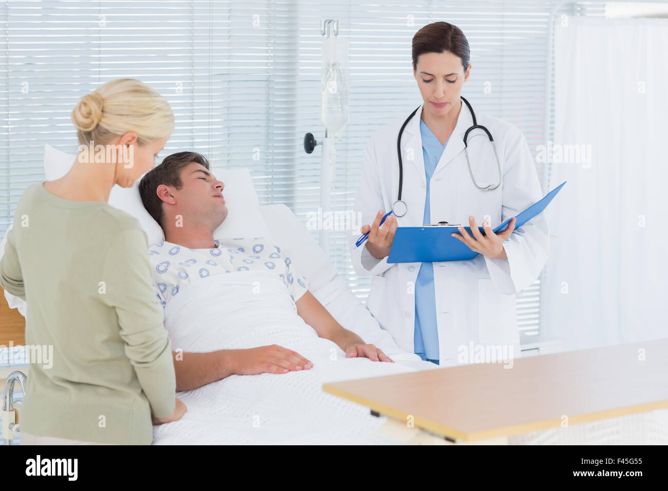Doctor checking her patient Stock Photo - Alamy