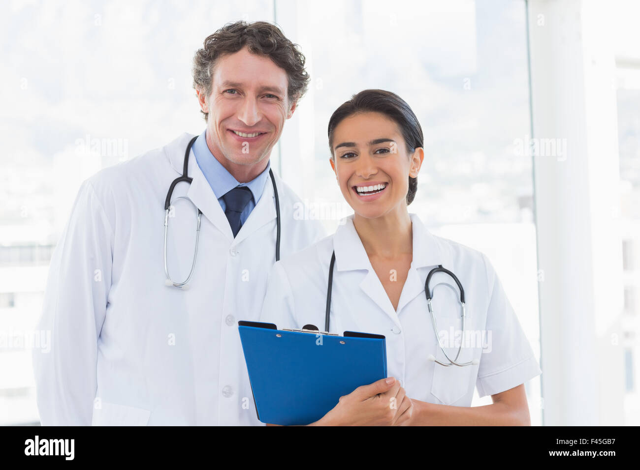 Happy doctors looking at camera Stock Photo - Alamy