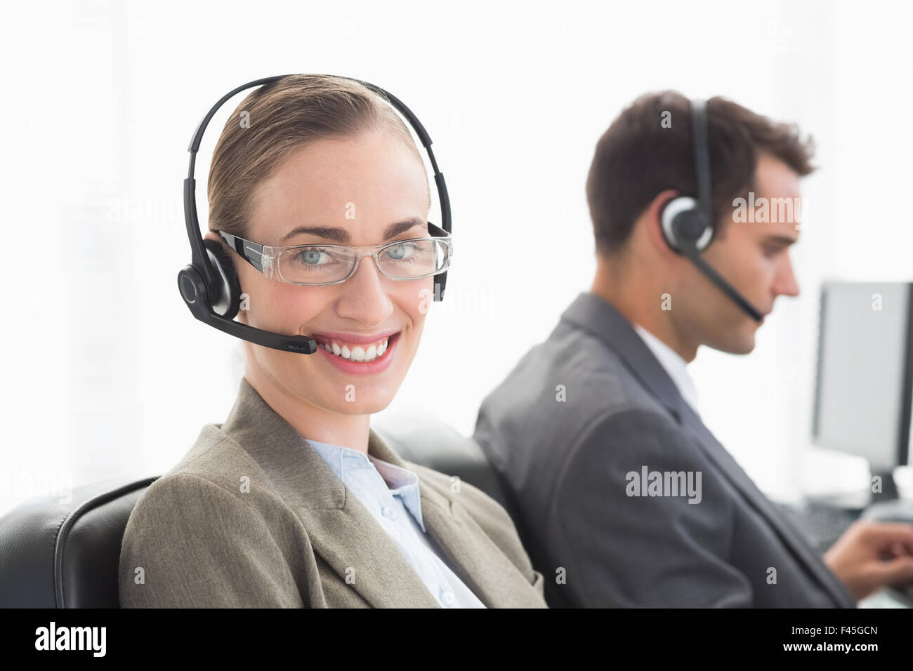 Business people with headsets using computers Stock Photo - Alamy