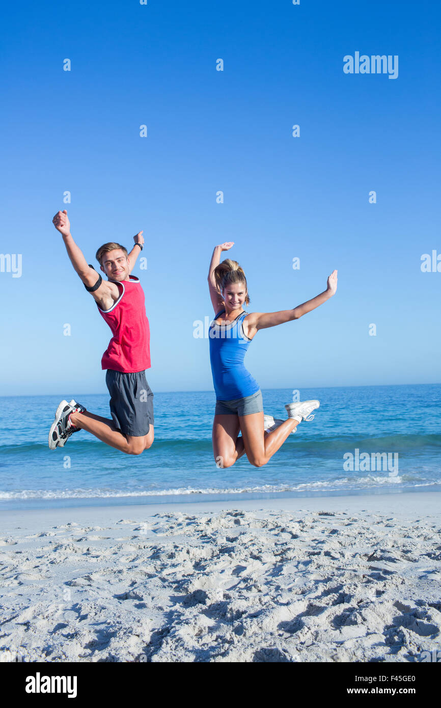 Happy couple jumping together Stock Photo - Alamy
