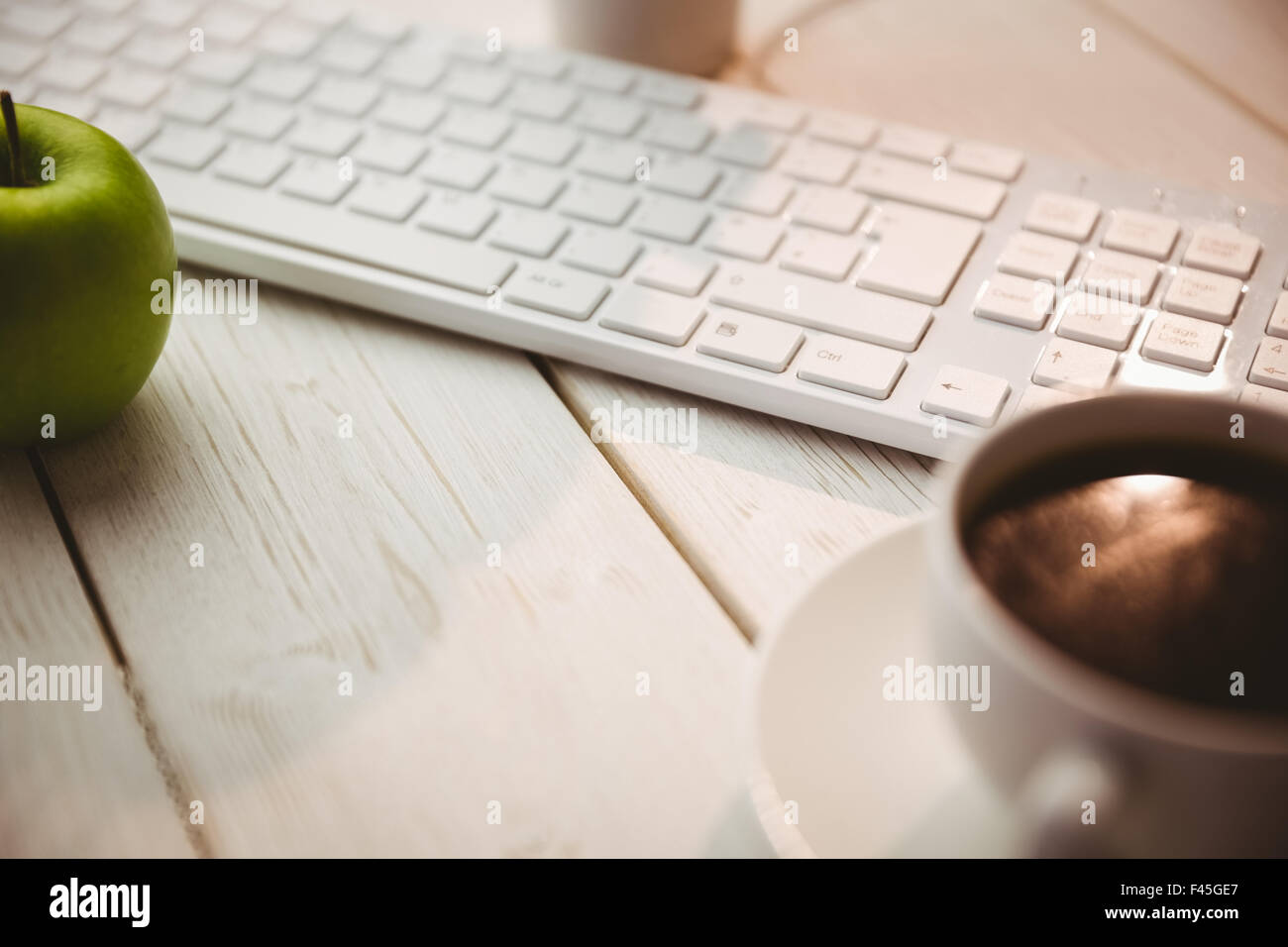 White keyboard and cup of coffee Stock Photo - Alamy