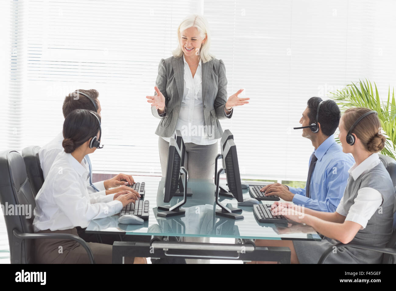 Smiling business people speaking together Stock Photo - Alamy