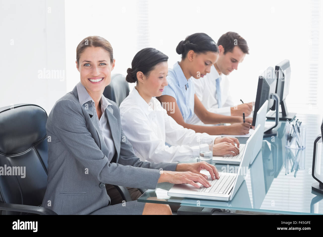 Business people using laptop Stock Photo - Alamy