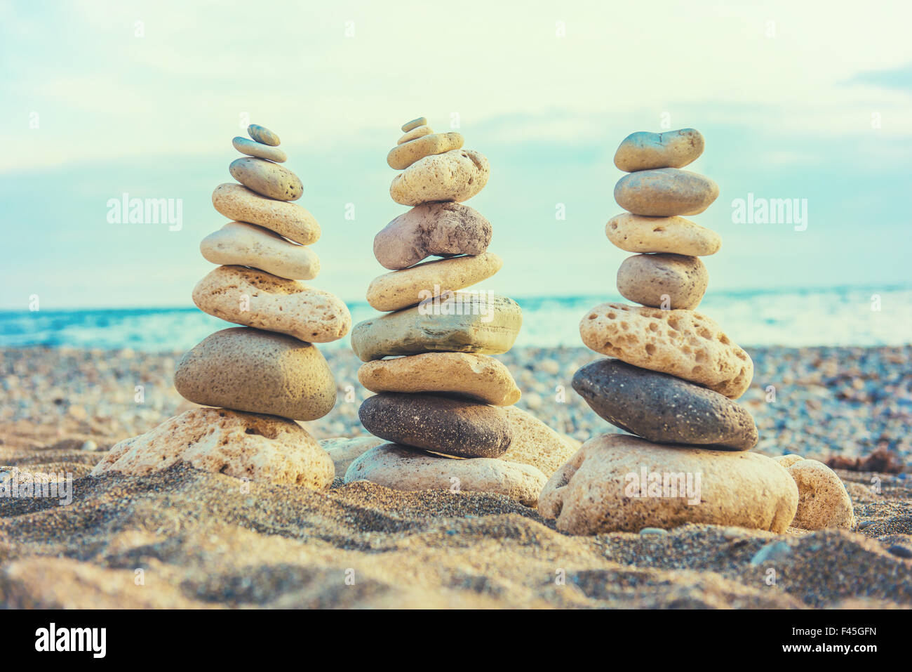 Three stacks of round smooth stones Stock Photo - Alamy